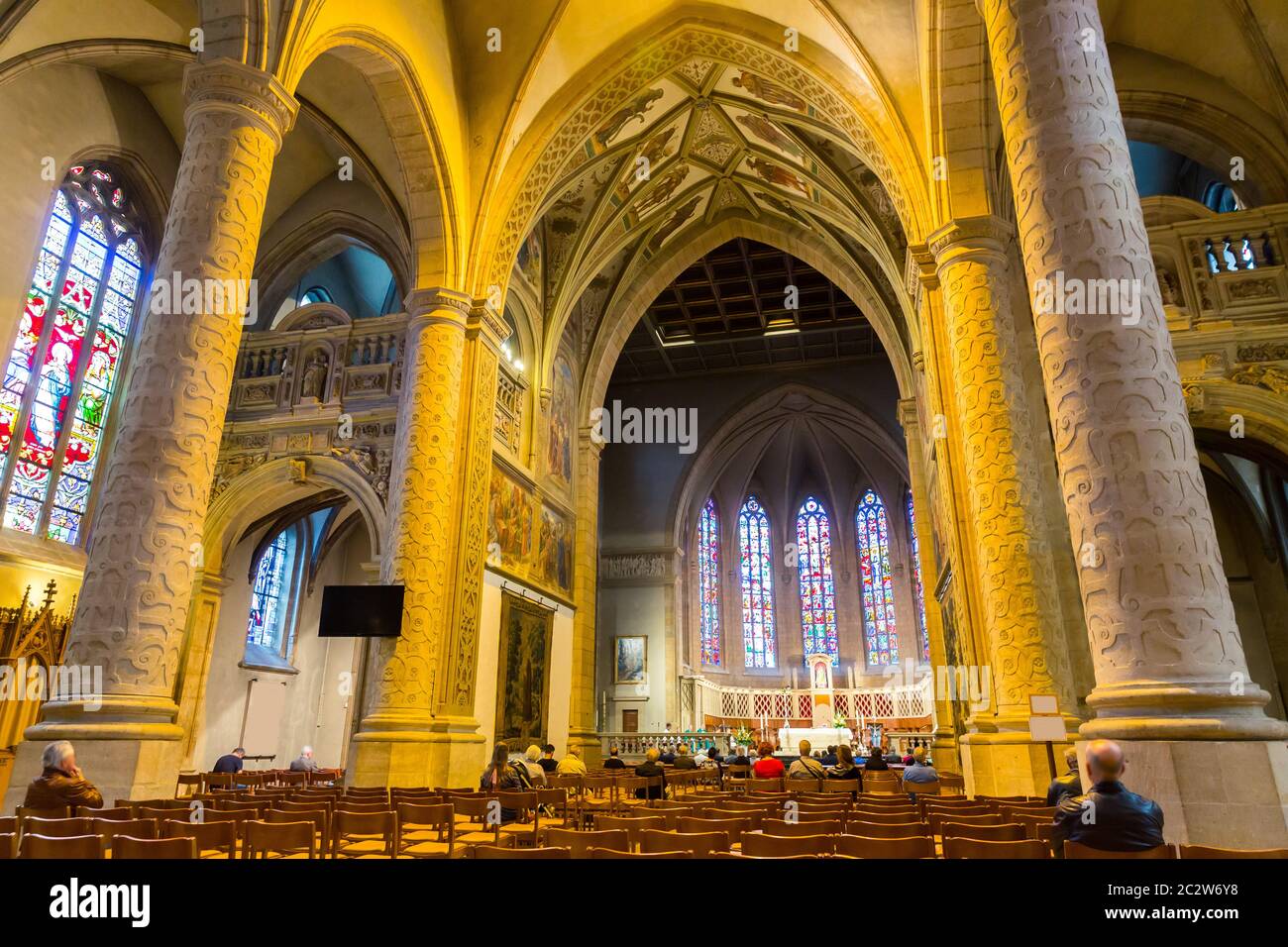 Service in hall of old temple, Europe. Ancient european architecture ...