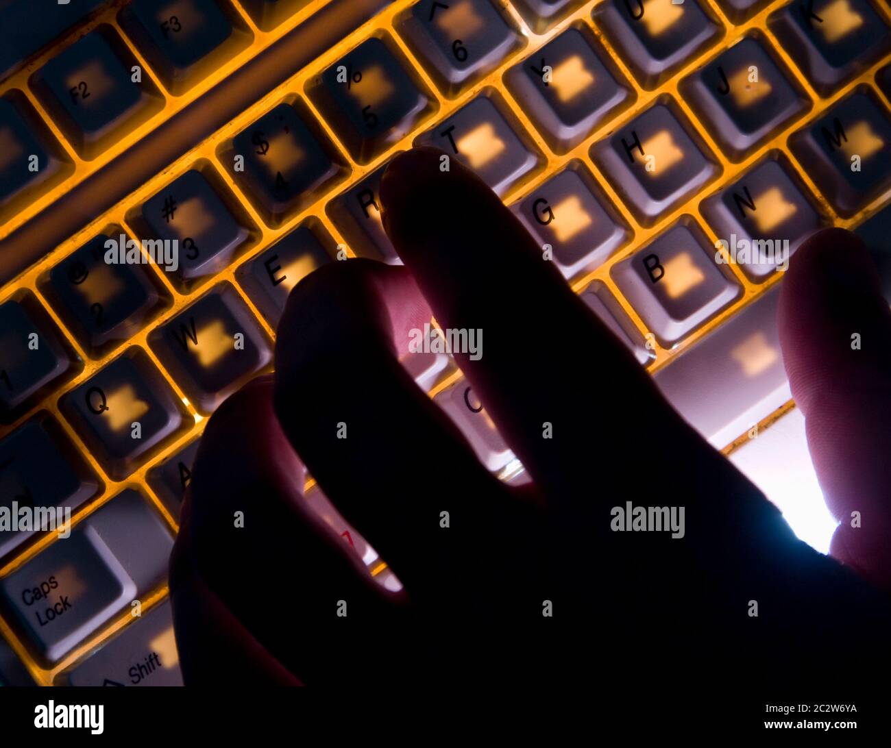 Silhouette of hands on lighting keyboard Stock Photo - Alamy