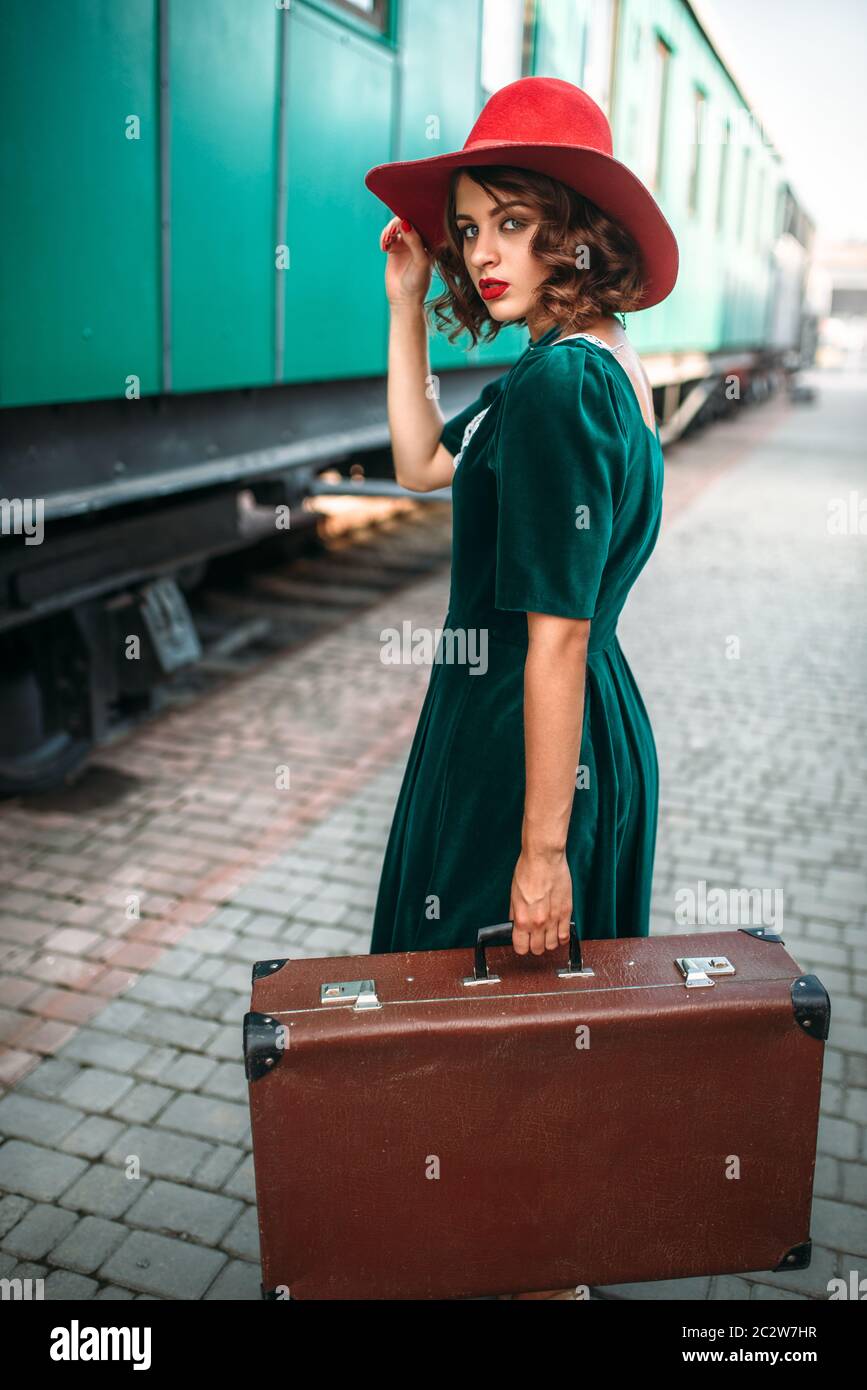 Young old-fashioned woman travels on retro train. Old locomotive ...