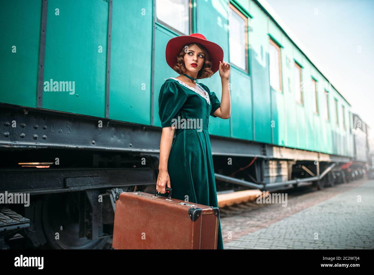 Young old-fashioned woman travels on retro train. Old locomotive ...