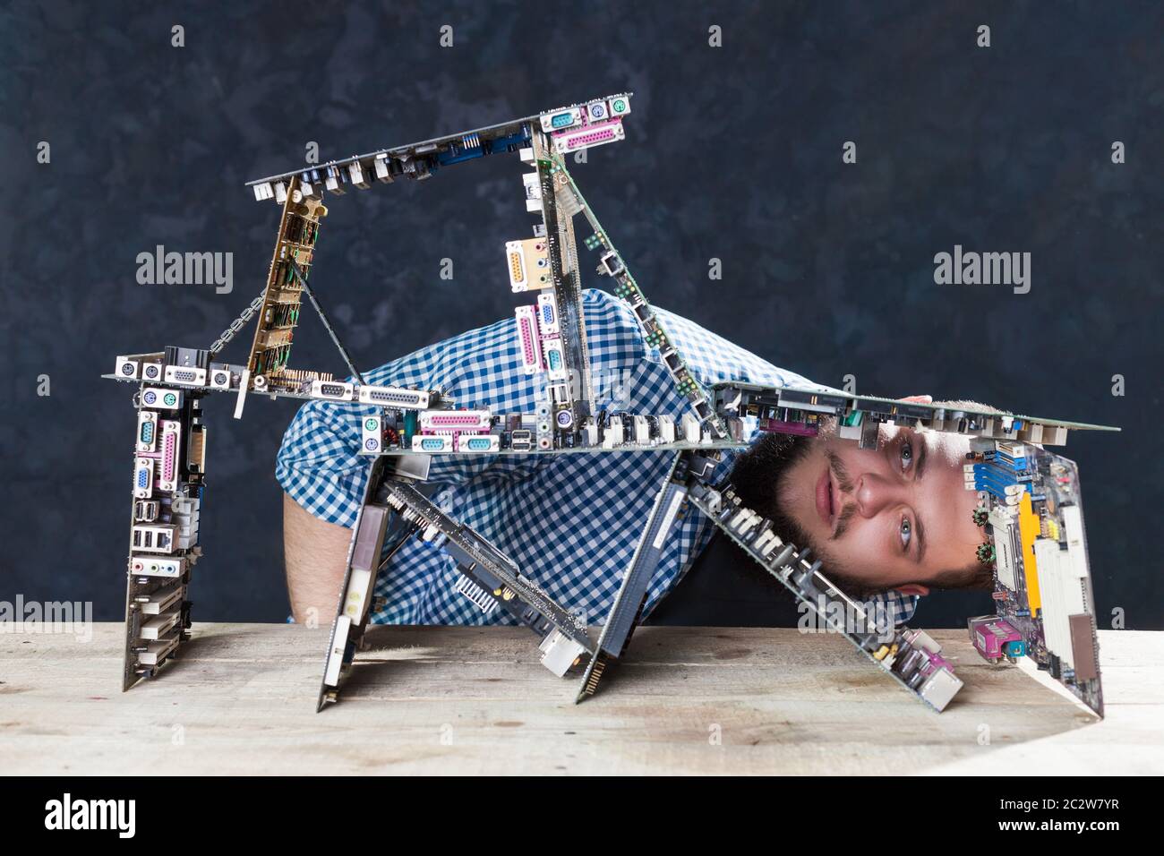 Service engineer builds house of cards from motherboards. Repairman ...
