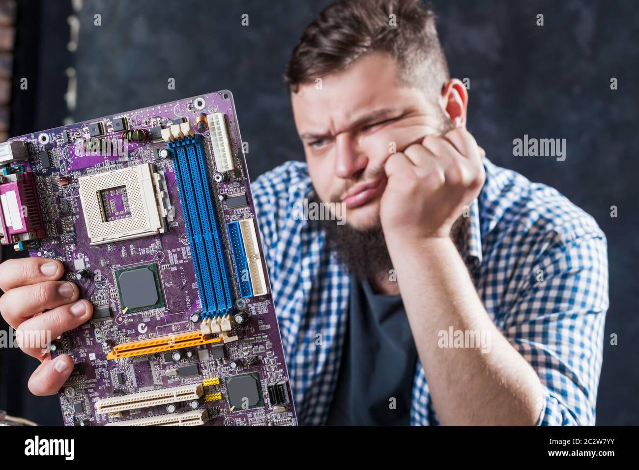 Service engineer fixing problem with computer motherboard. Repairman ...