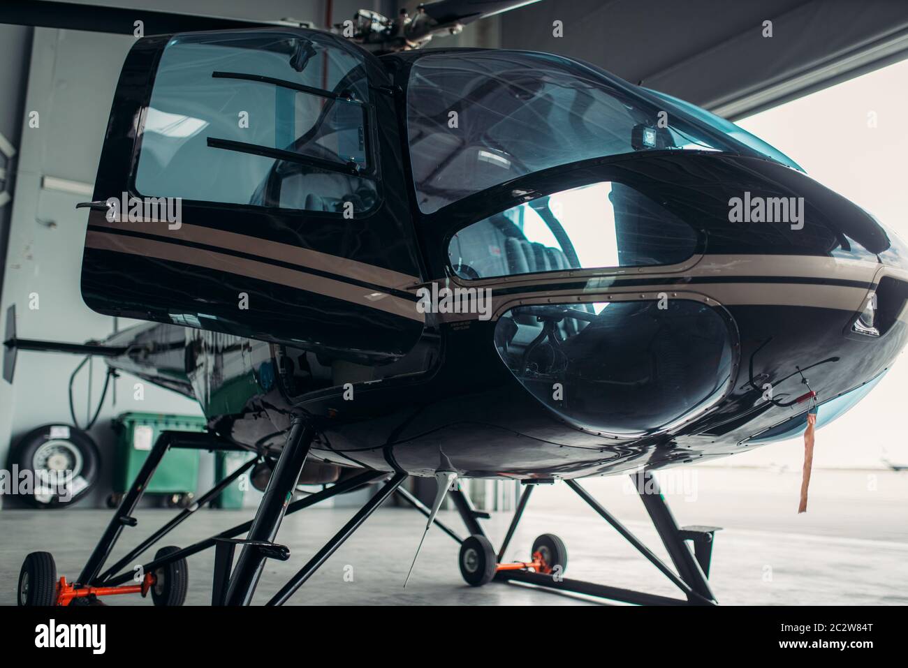 Small helicopter in hangar, nobody. Private airline copter. Chopper ...