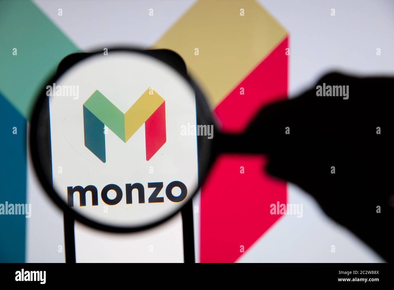 LONDON, UK - June 2020: Monzo online banking logo under a magnifying ...