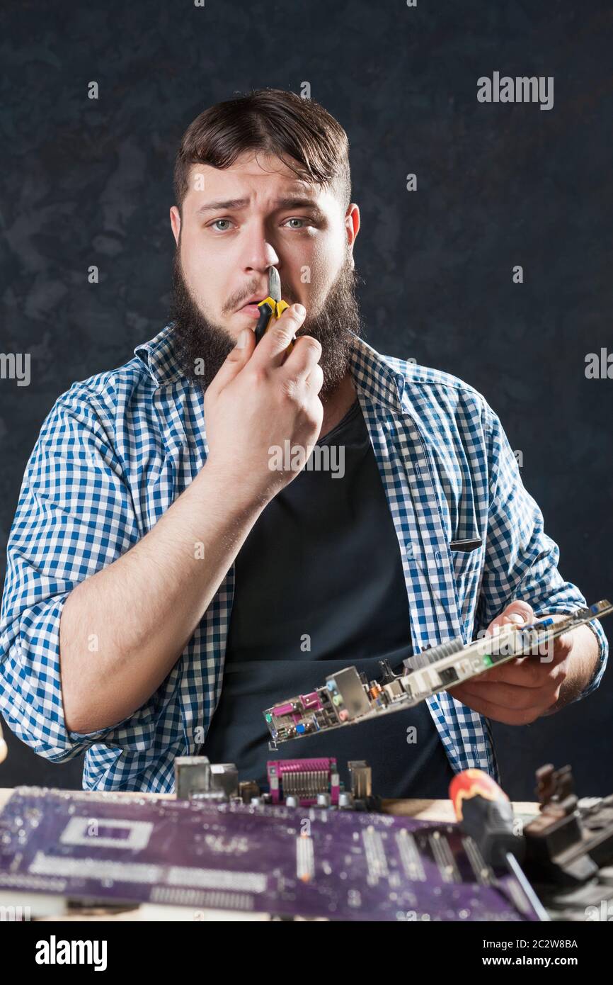 Male engineer repair pc motherboard. Repairman makes electronic ...