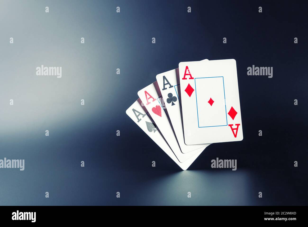 Four aces on dark background Stock Photo - Alamy