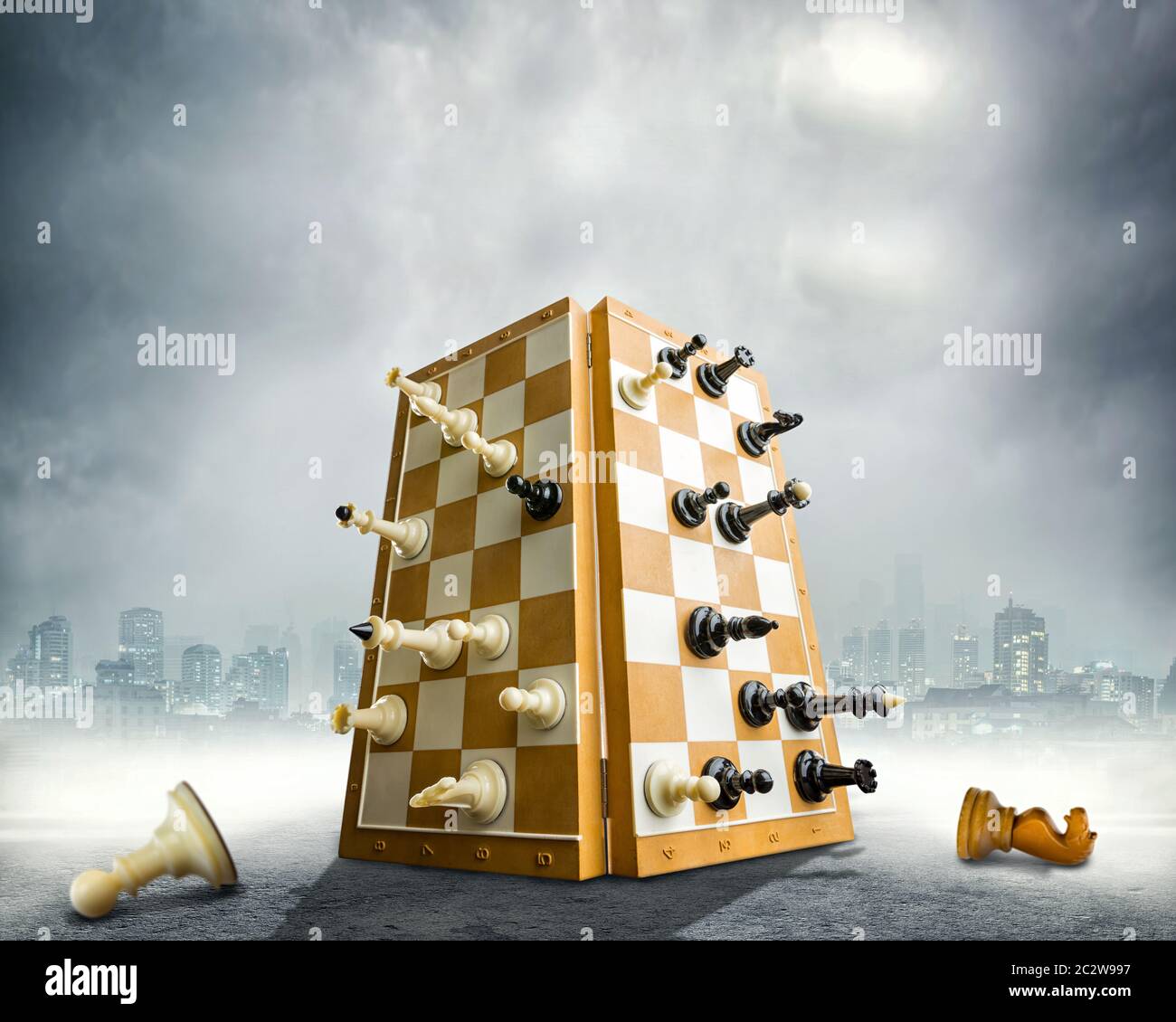 Chess figures sticked to the chess board over foggy city background ...