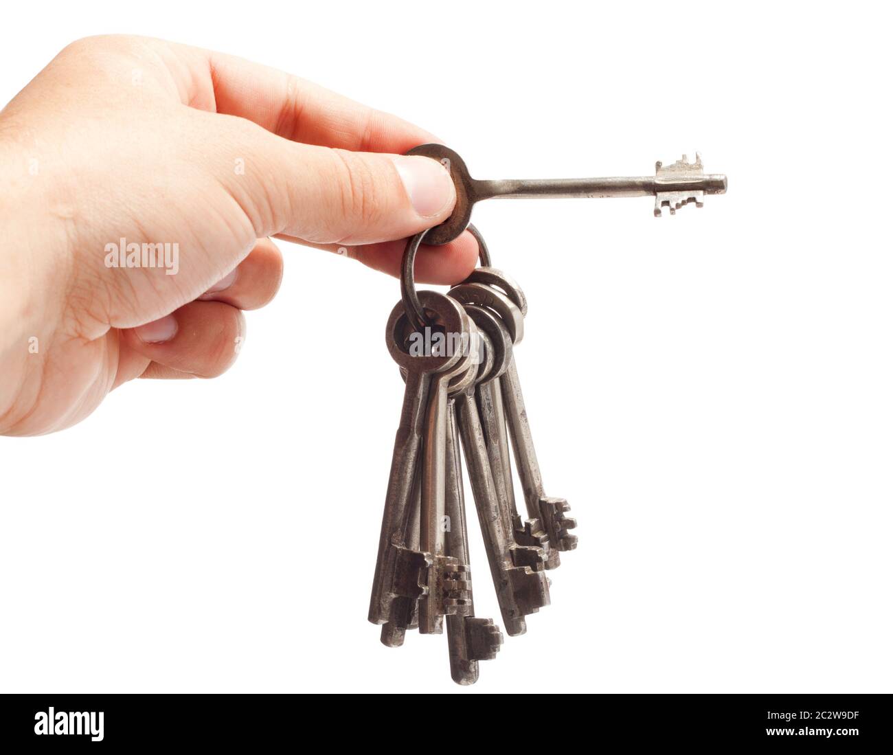 Old rusty bunch of keys in hand. Isolated on white Stock Photo - Alamy