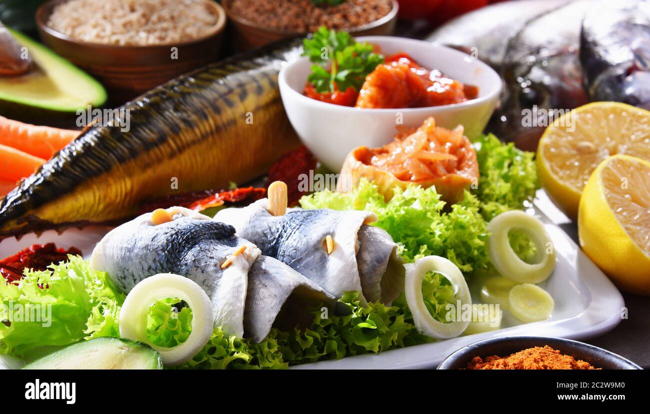 Different sorts of fish on kitchen table Stock Photo - Alamy