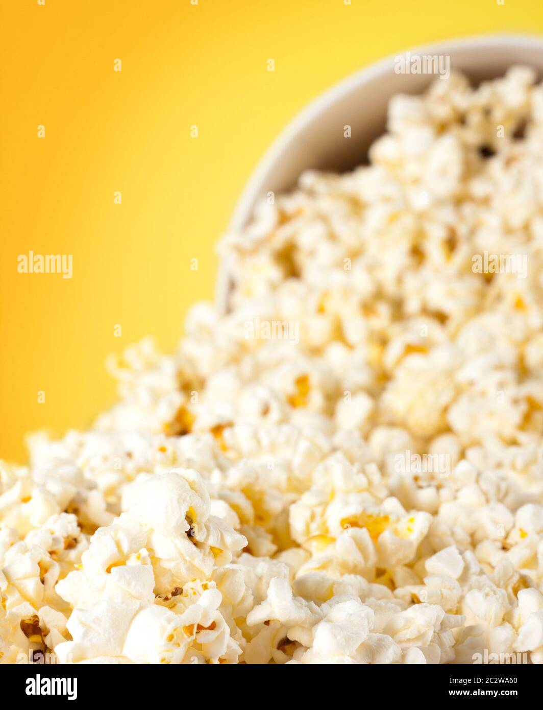 Popcorn falling out from bucket Stock Photo - Alamy