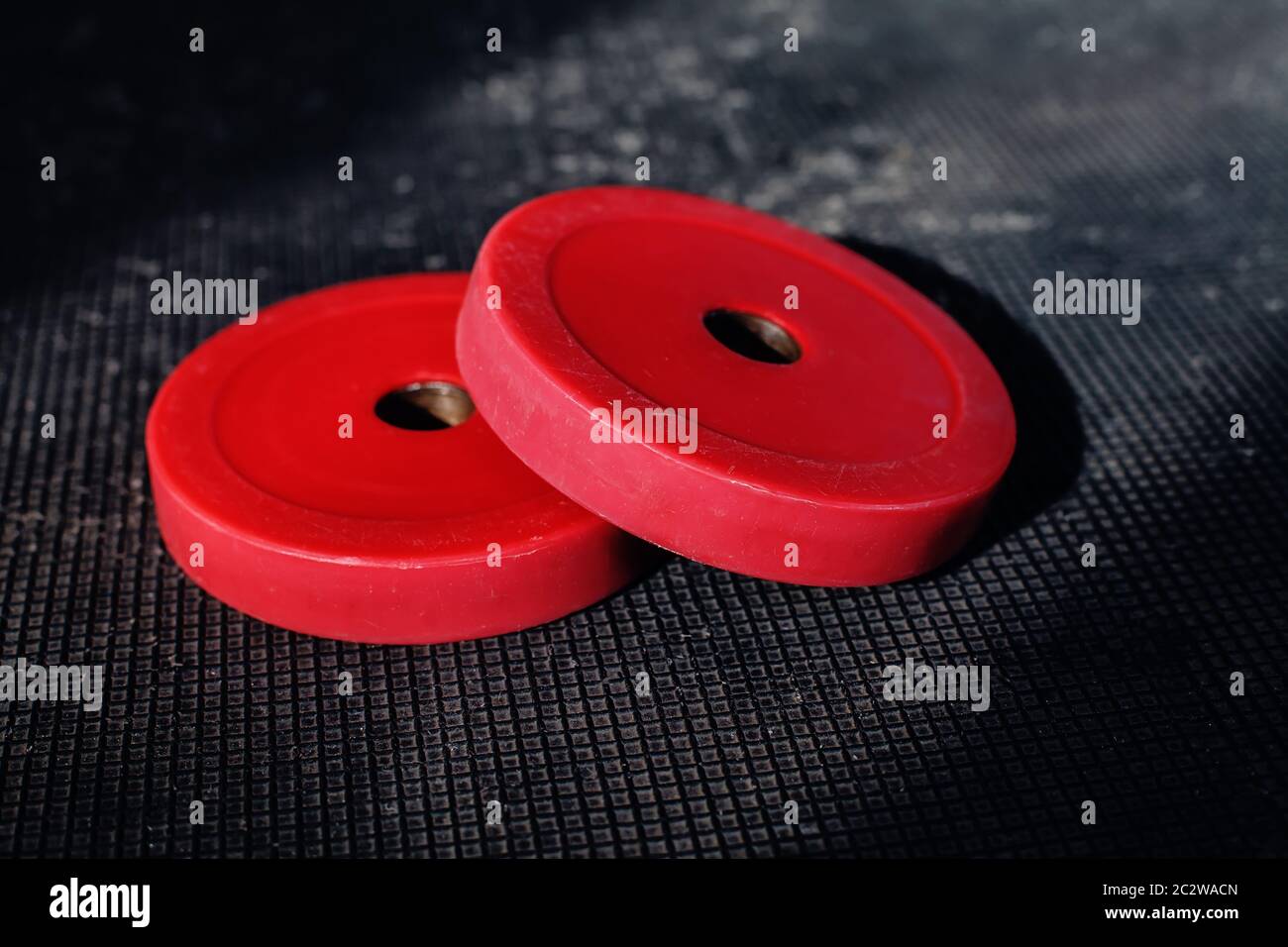 Red weight plates on the floor in the gym Stock Photo - Alamy