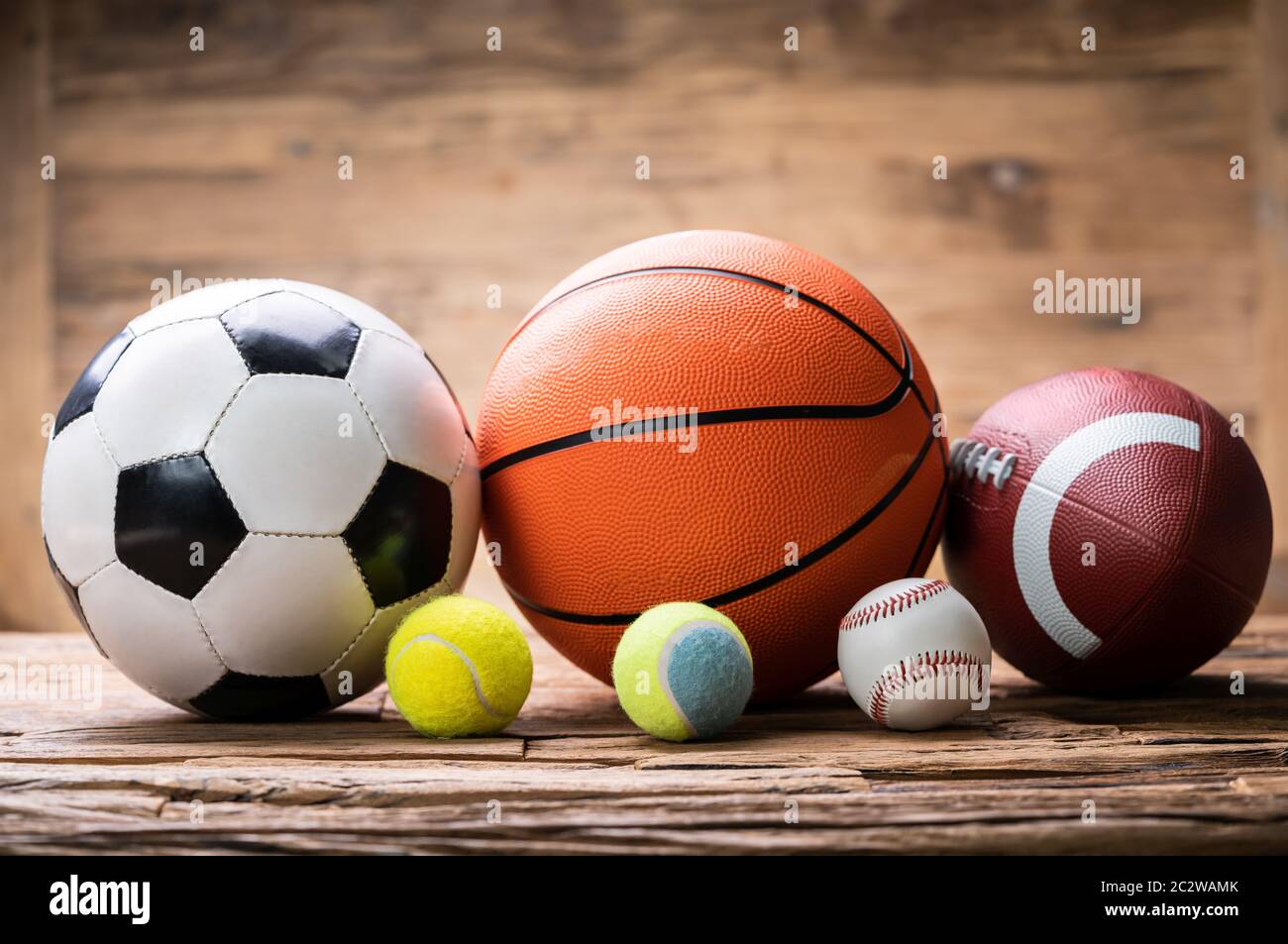 Different Sport Balls Arranged In Row Over Rough Wooden Plank Stock ...
