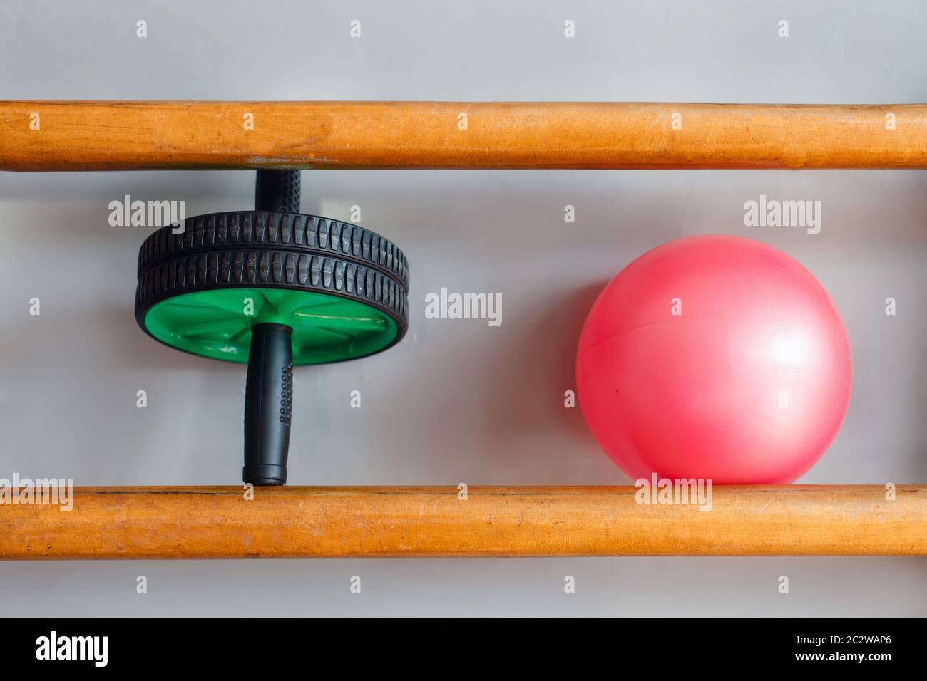 Crossfit equipment: ab roller and ball on the shelf Stock Photo - Alamy