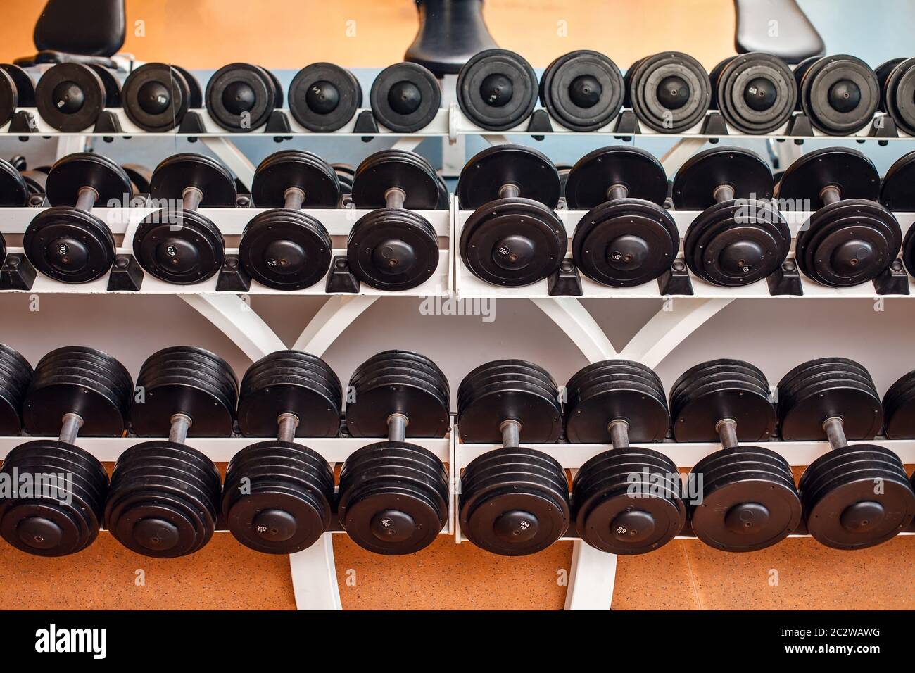 Set of dumbbells on the stand in the gym Stock Photo - Alamy
