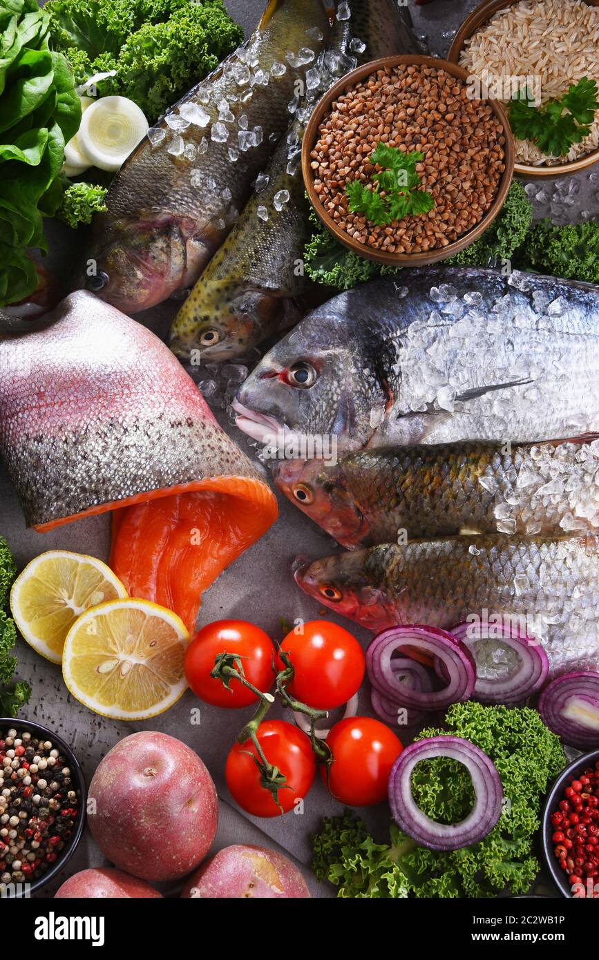 Different sorts of fish on kitchen table Stock Photo - Alamy