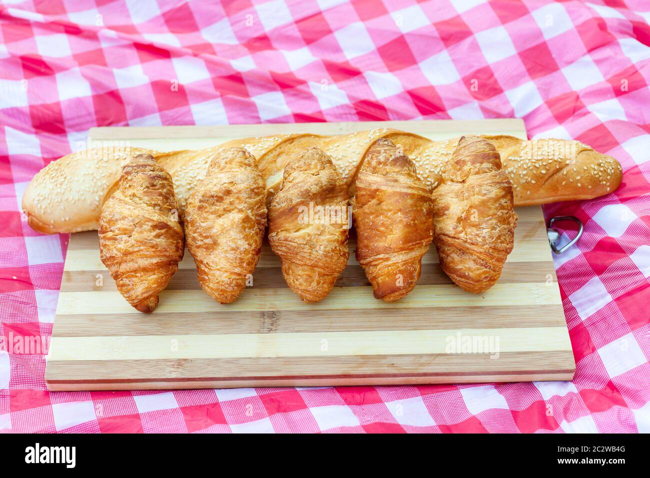 Croissants and French bread for picnic on the board Stock Photo - Alamy