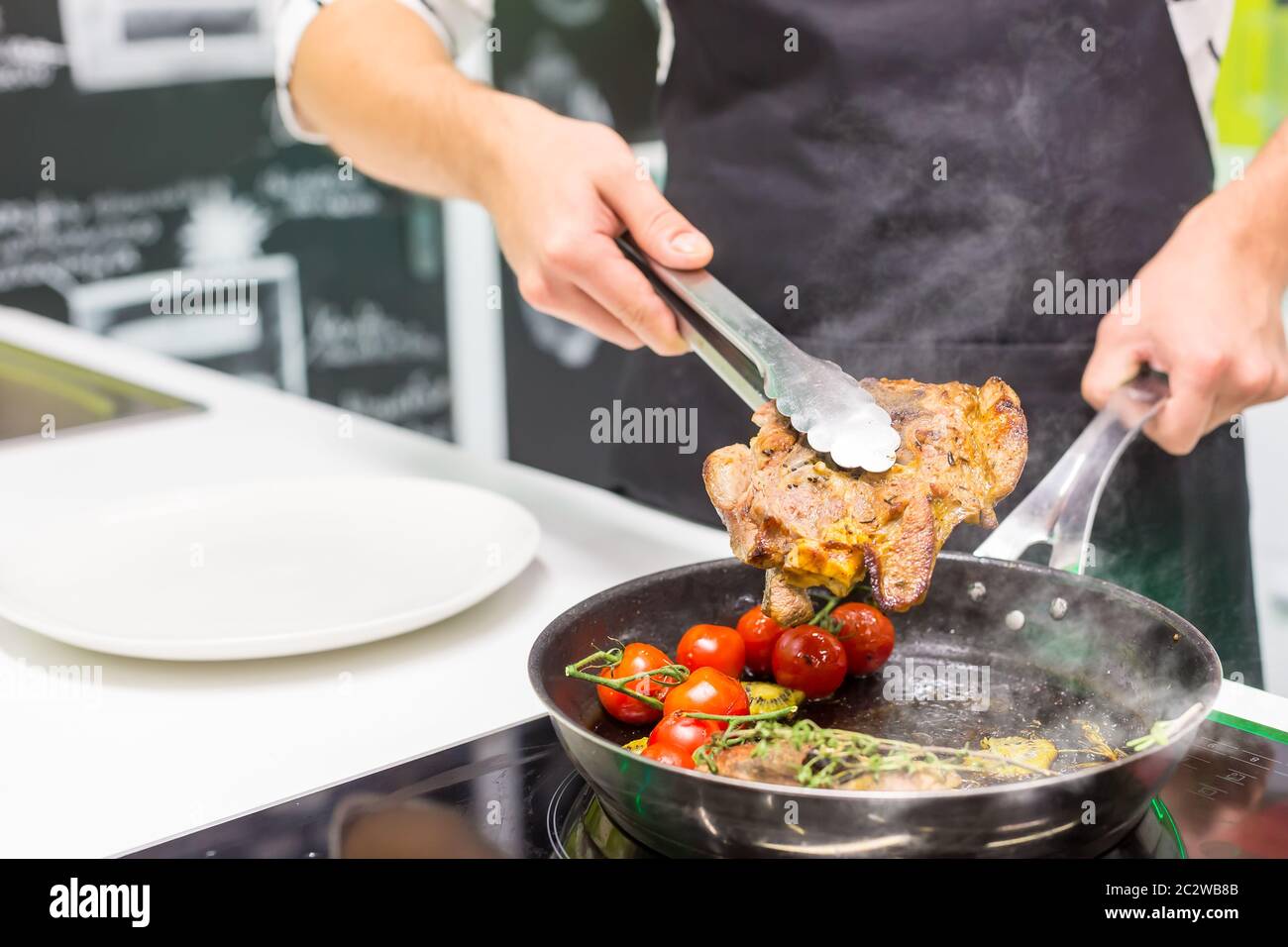 Close up of chef cooking meat with vegetables Stock Photo - Alamy