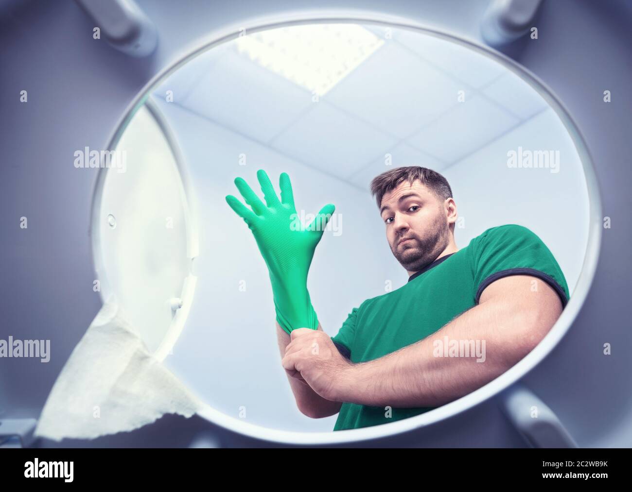 Man in the bathroom in rubber glove ready to clean the toilet Stock ...