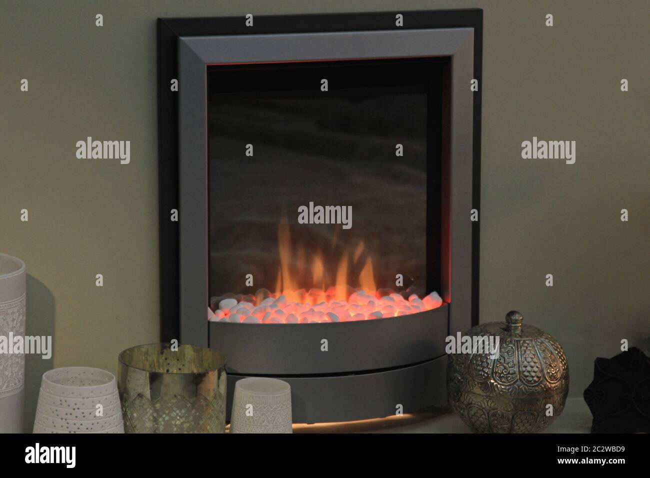 Artificial Fire in Electric Fireplace With White Stones Stock Photo - Alamy