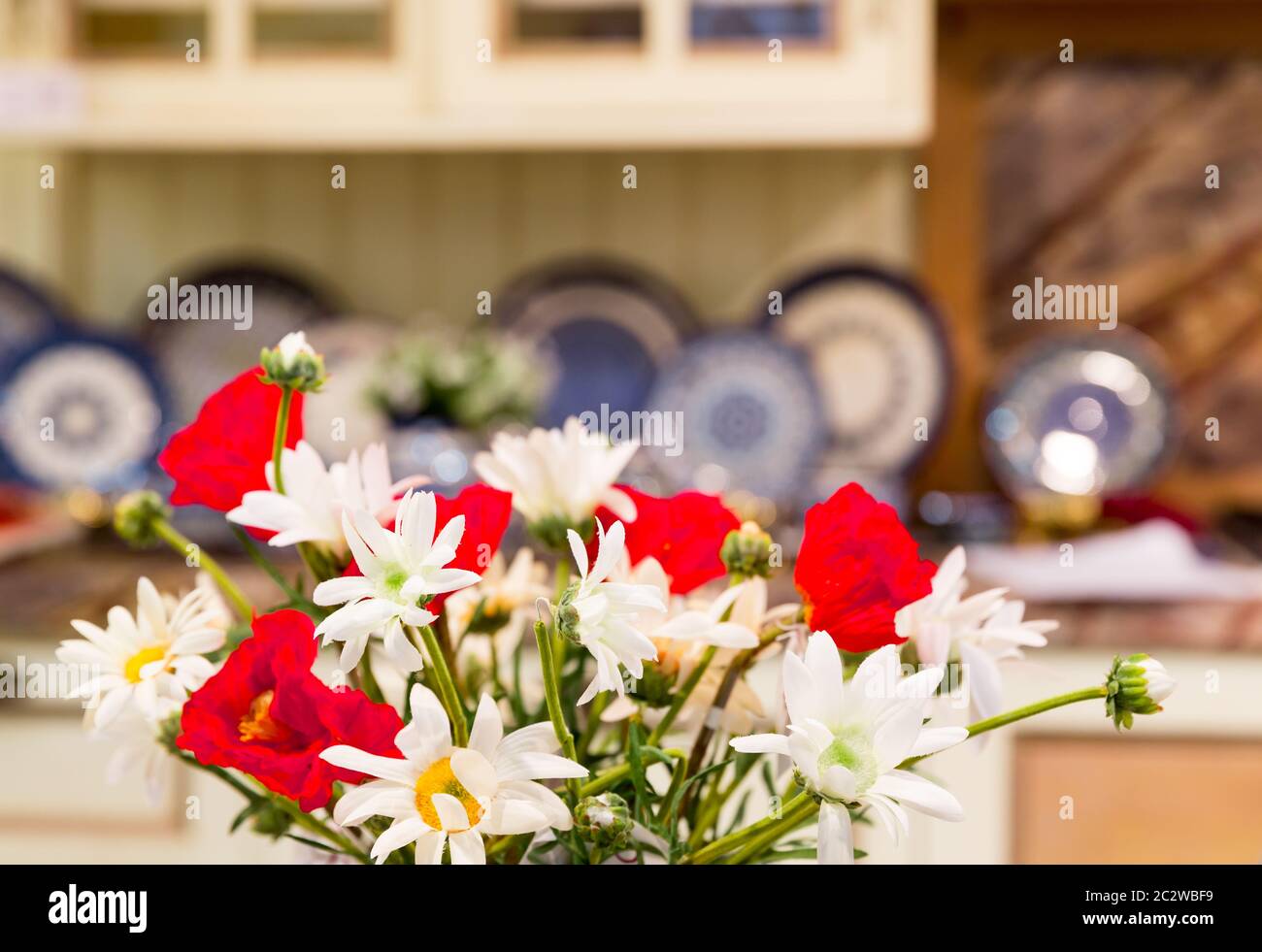 Luxury kitchen made from light wood with nice flowers Stock Photo - Alamy