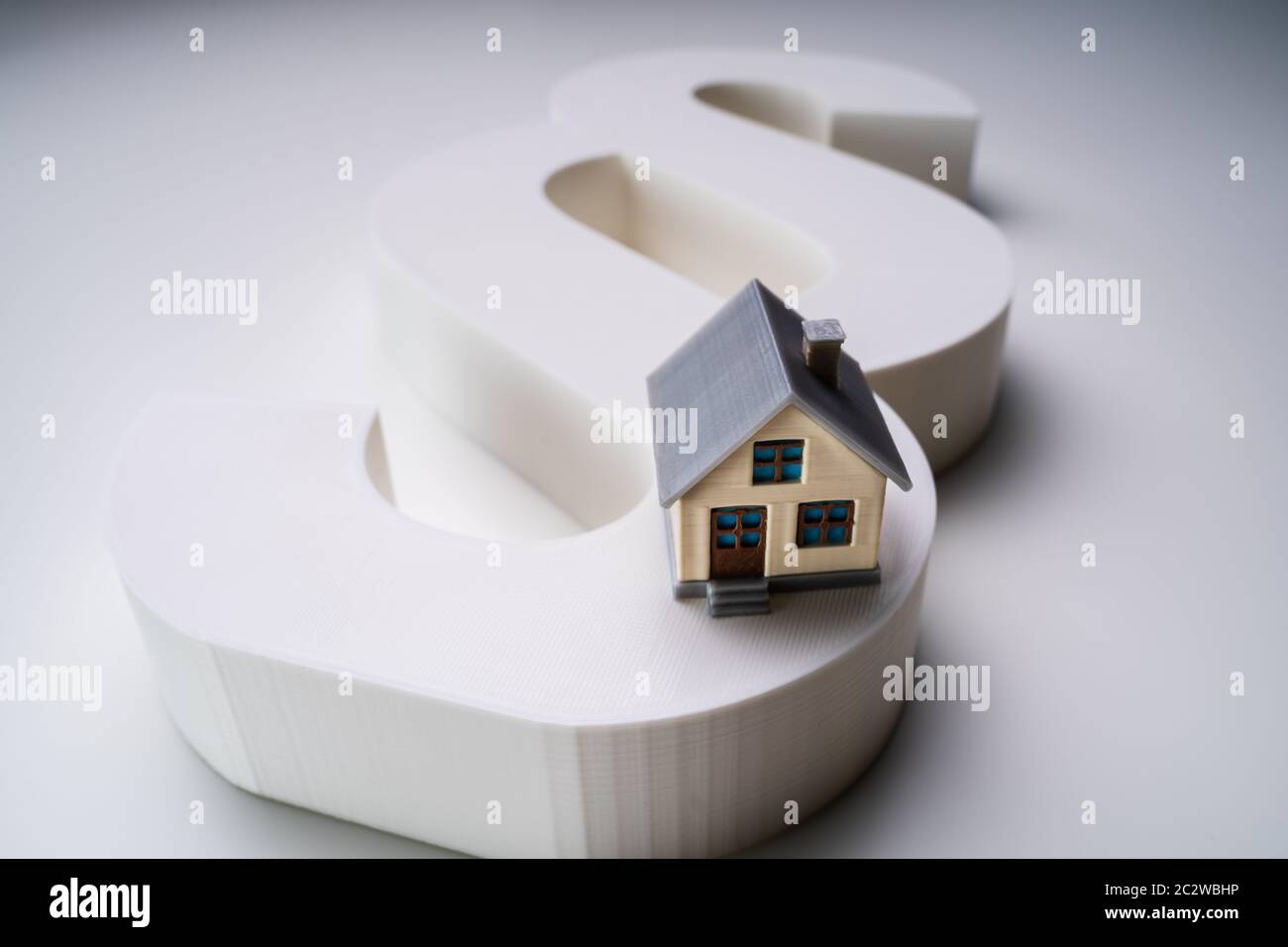 Close-up Of A House Model With Paragraph Symbol Over White Background ...