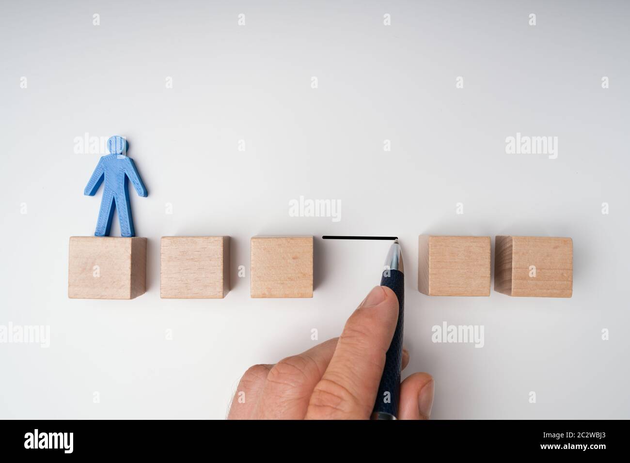 Human Hand Filling Gap Between Wooden Blocks Arranged In A Row With ...