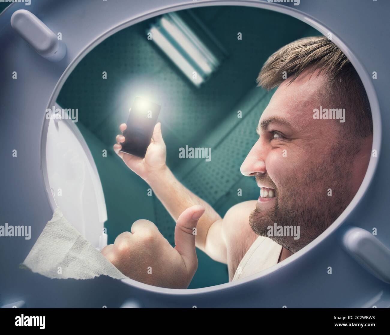 Strange happy man making selfie near the toilet bowl Stock Photo - Alamy