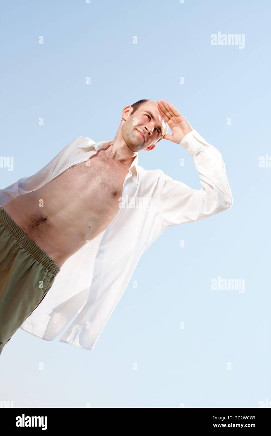 Serious man in white shirt looking afar Stock Photo - Alamy
