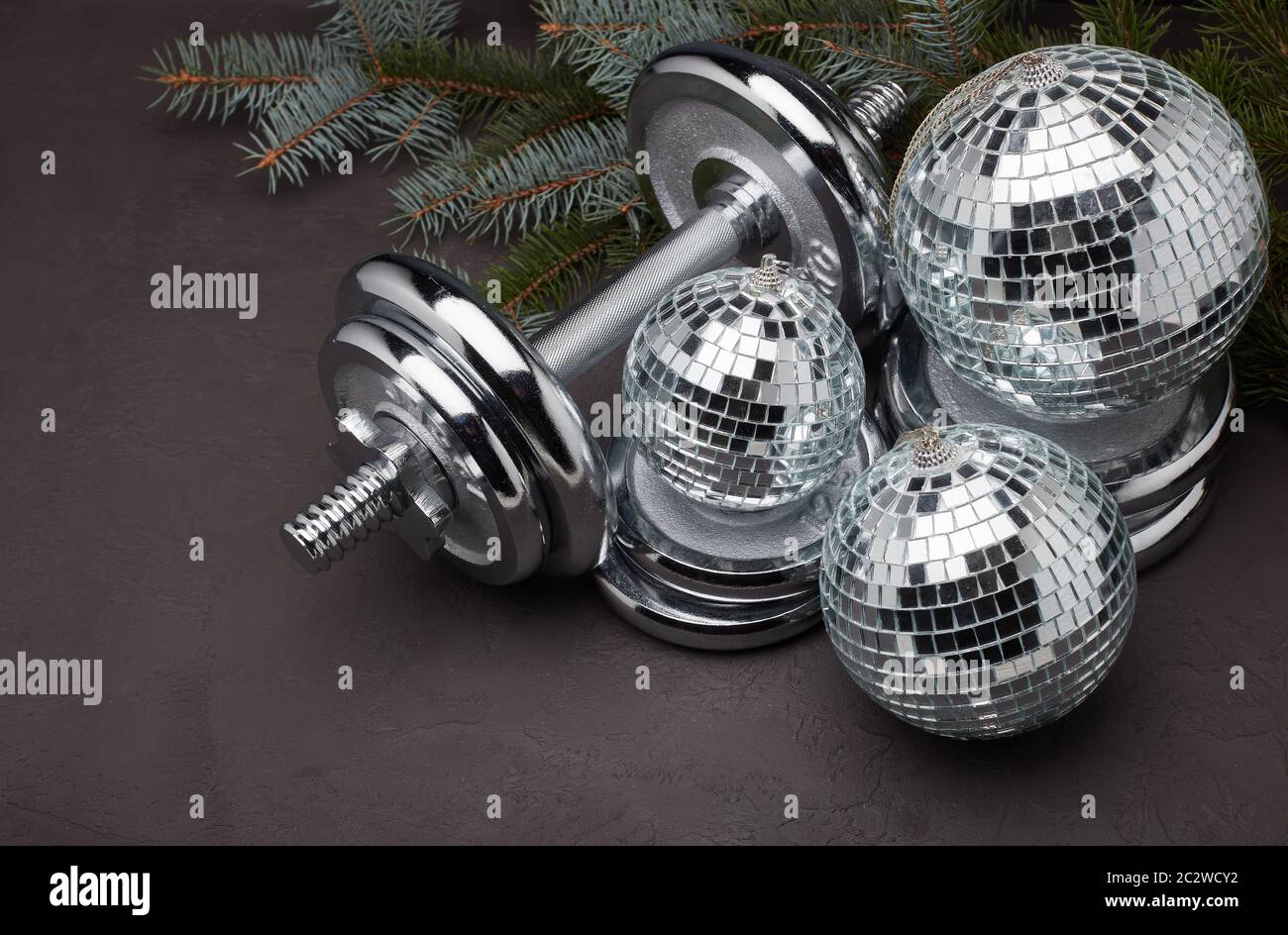 Sports equipment (dumbbell with weights), fir branch, Christmas ...