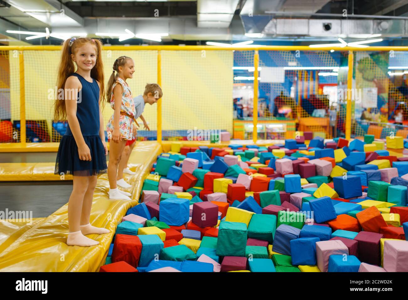 Cute children jumping on kids trampoline, playground in entertainment ...