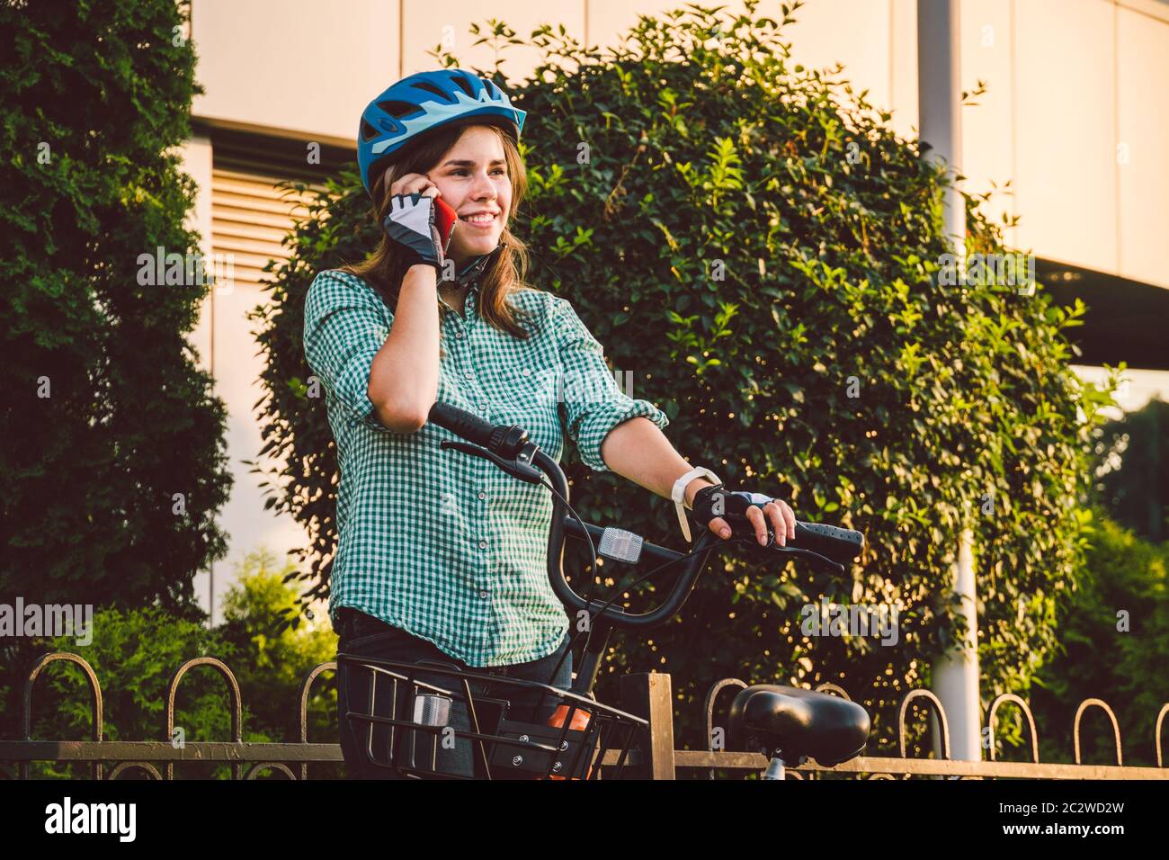 Portrait Of A Cheerful Girl Holding Mobile Phone. Happy smiling student ...