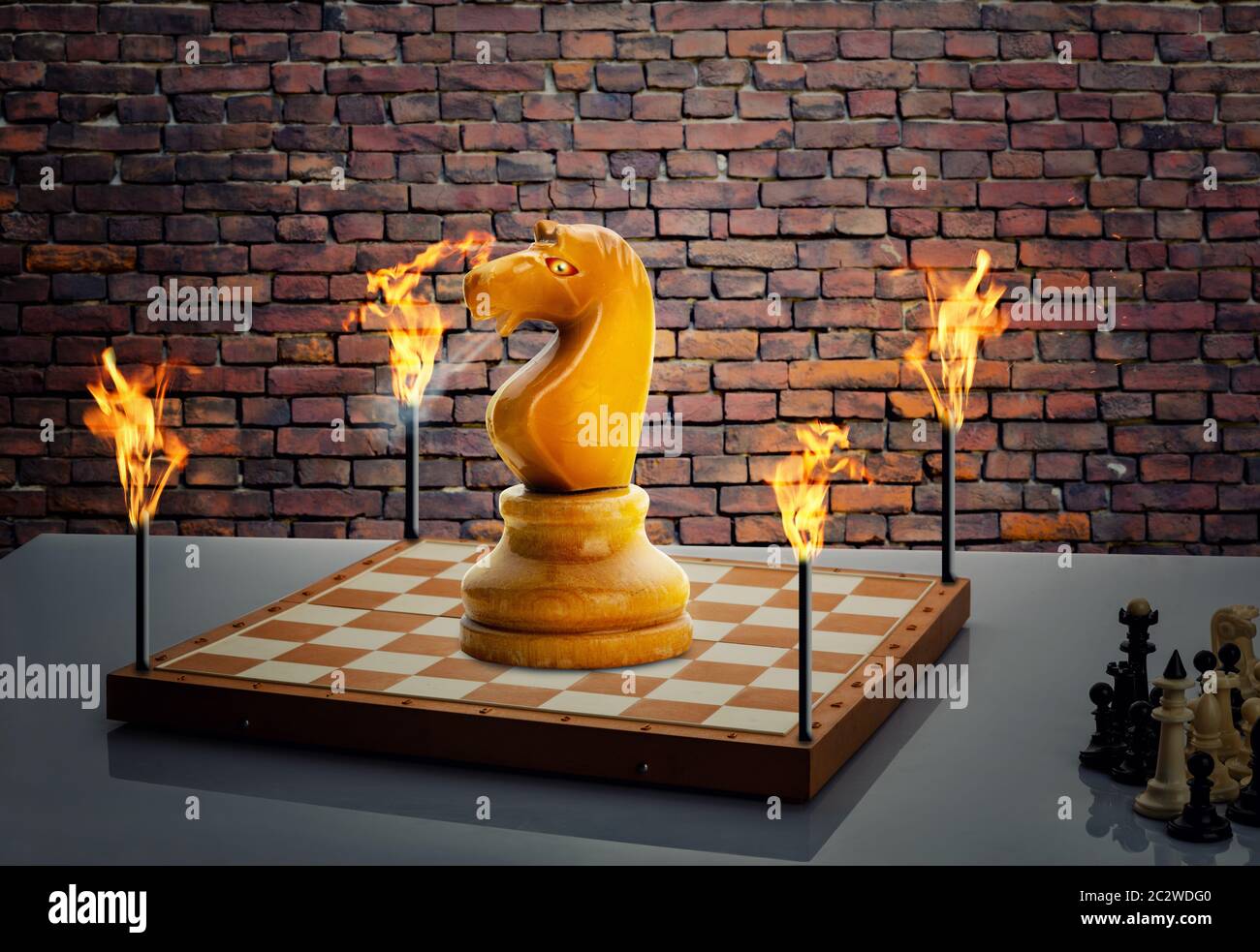Big knight on the chess board with torches on the corners Stock Photo ...