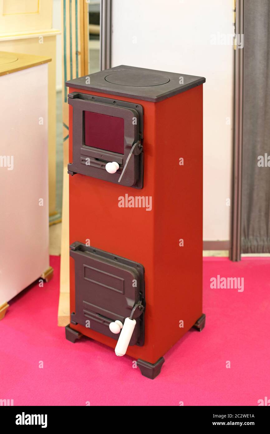 Modern New Red Wood Burning Stove in Home Stock Photo - Alamy
