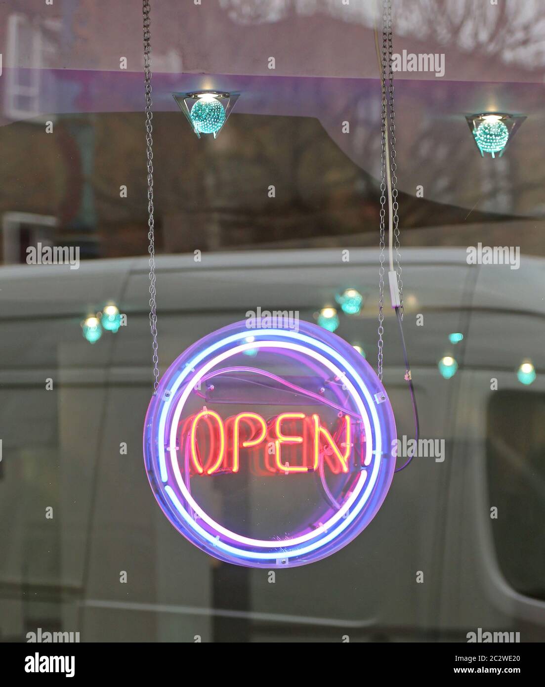 Open Round Neon Sign in Shop Window Reflection Stock Photo - Alamy