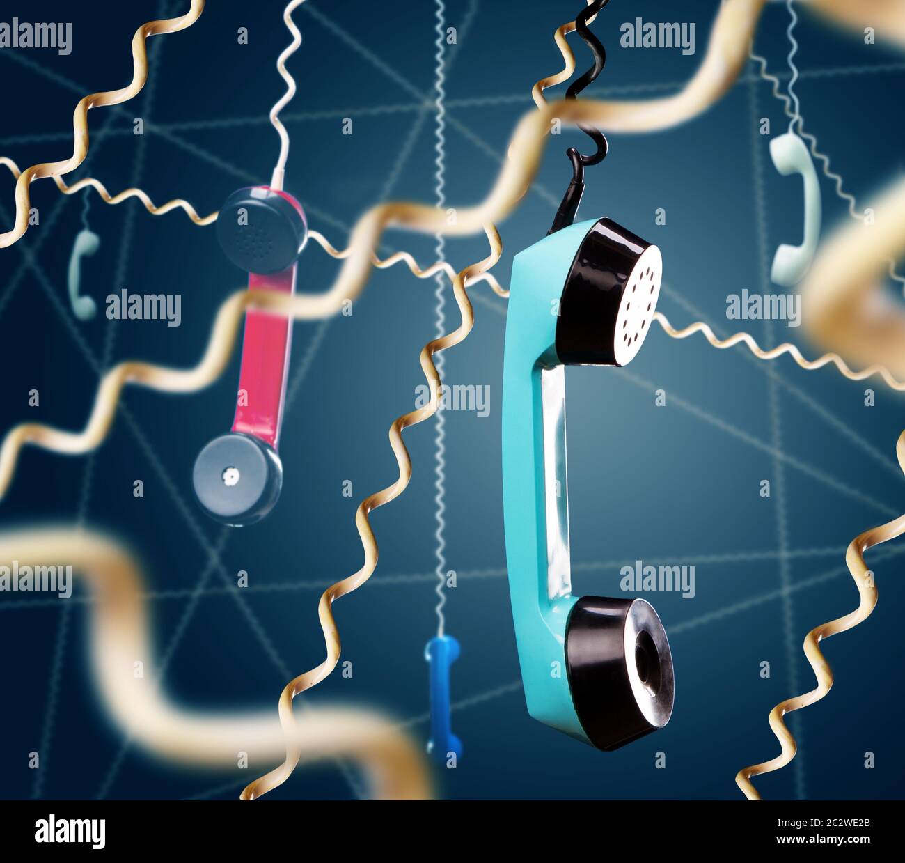 Lots of hanging retro telephone handsets Stock Photo - Alamy