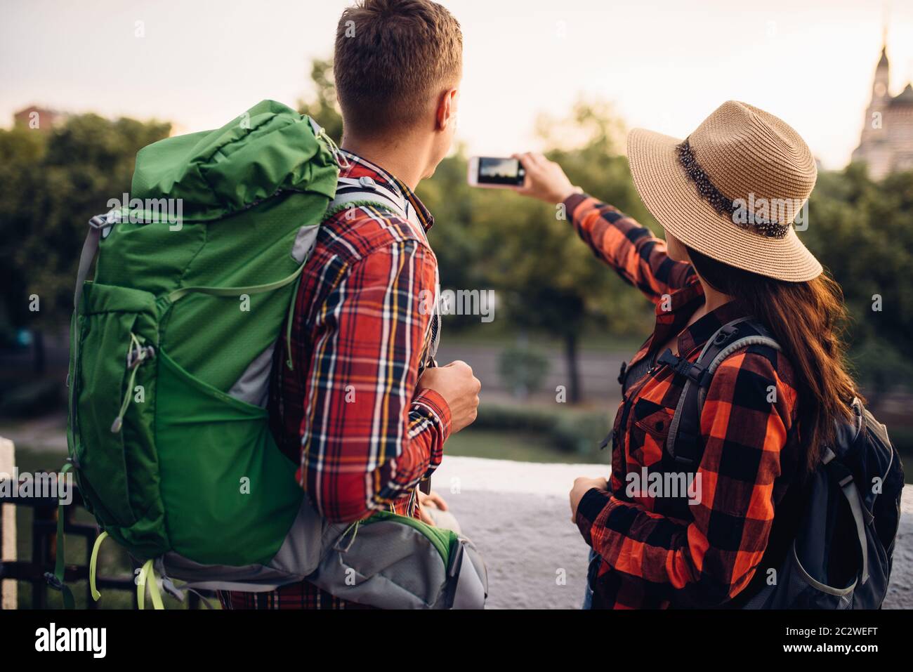 Hikers with backpacks makes selfie on excursion in tourist town. Summer ...
