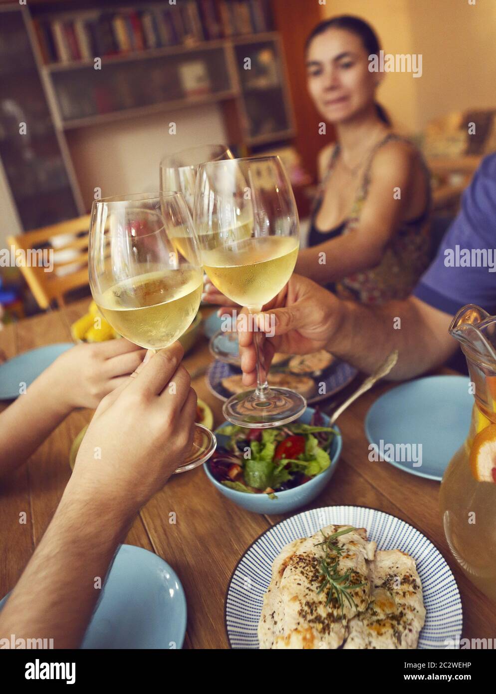 Hands of a group of people cheering with white wine Stock Photo - Alamy