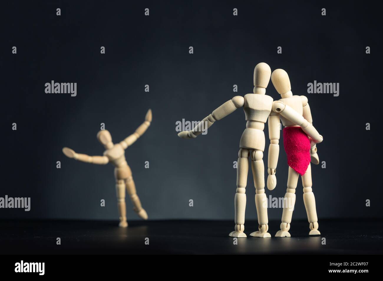 Family of wooden figures, child having fun Stock Photo - Alamy