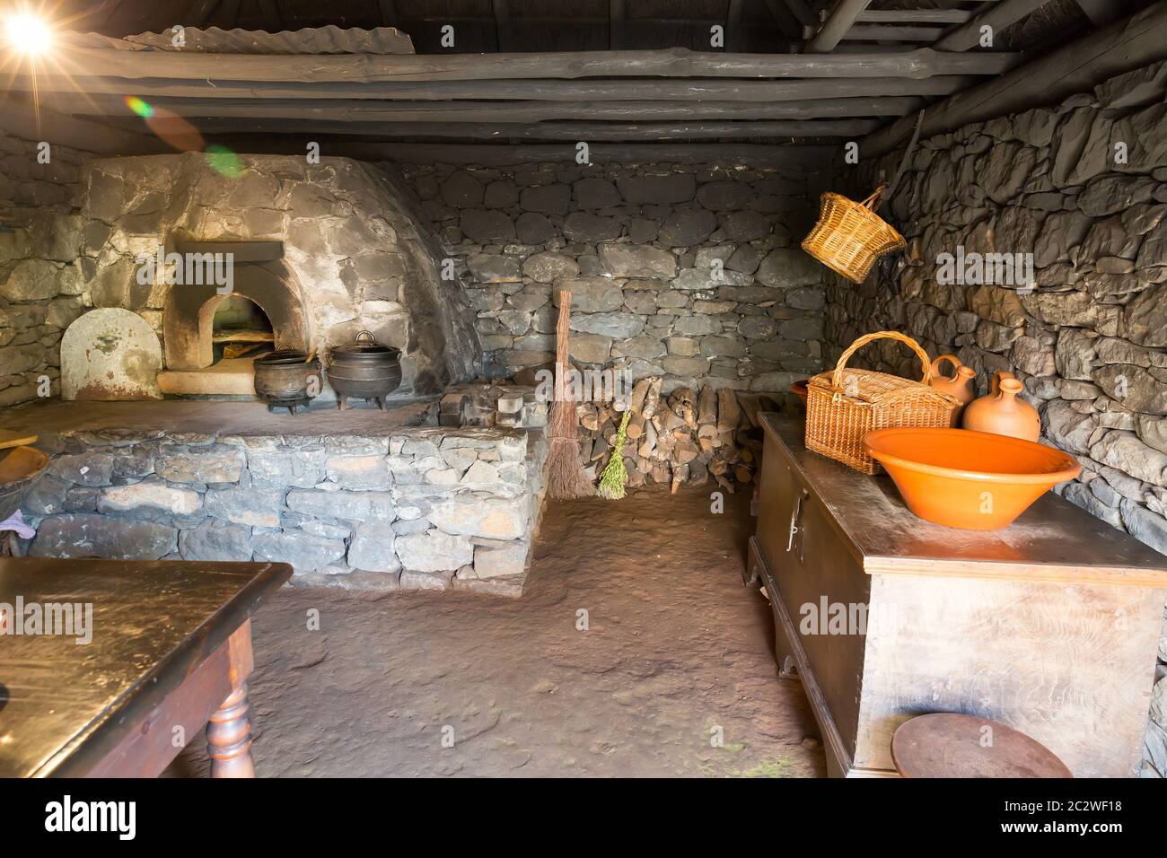 Ancient kitchen interior with furnace, pots and lumber Stock Photo - Alamy