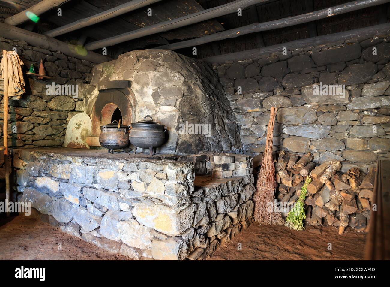 Ancient kitchen interior with furnace, pots and lumber Stock Photo - Alamy