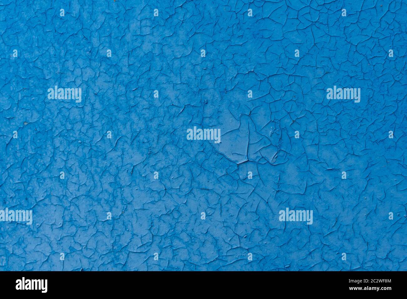 beautifully cracked blue paint on a metal surface. texture of drought ...