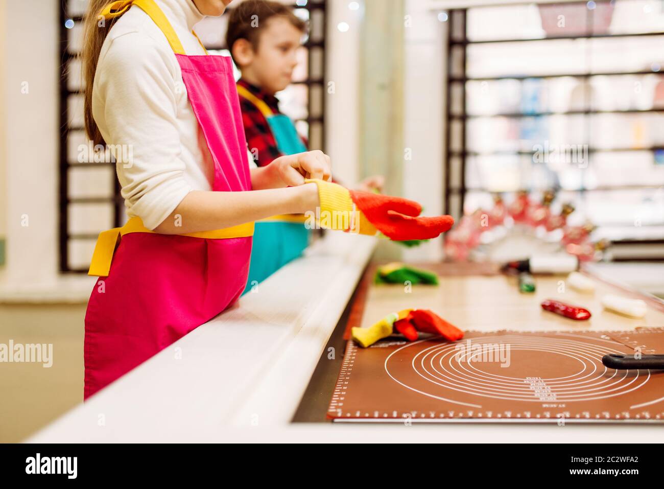 Children in workshop at pastry shop learn to make caramel. Holiday fun ...