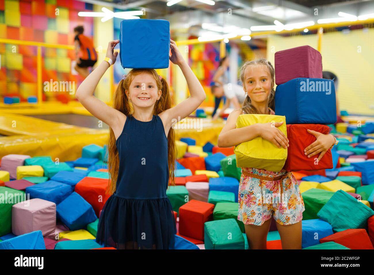 Two little girls playing with soft cubes, playground in entertainment ...