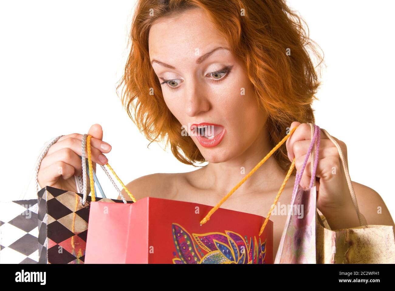 Unexpected shopping. Surprised woman looking into the bag Stock Photo ...