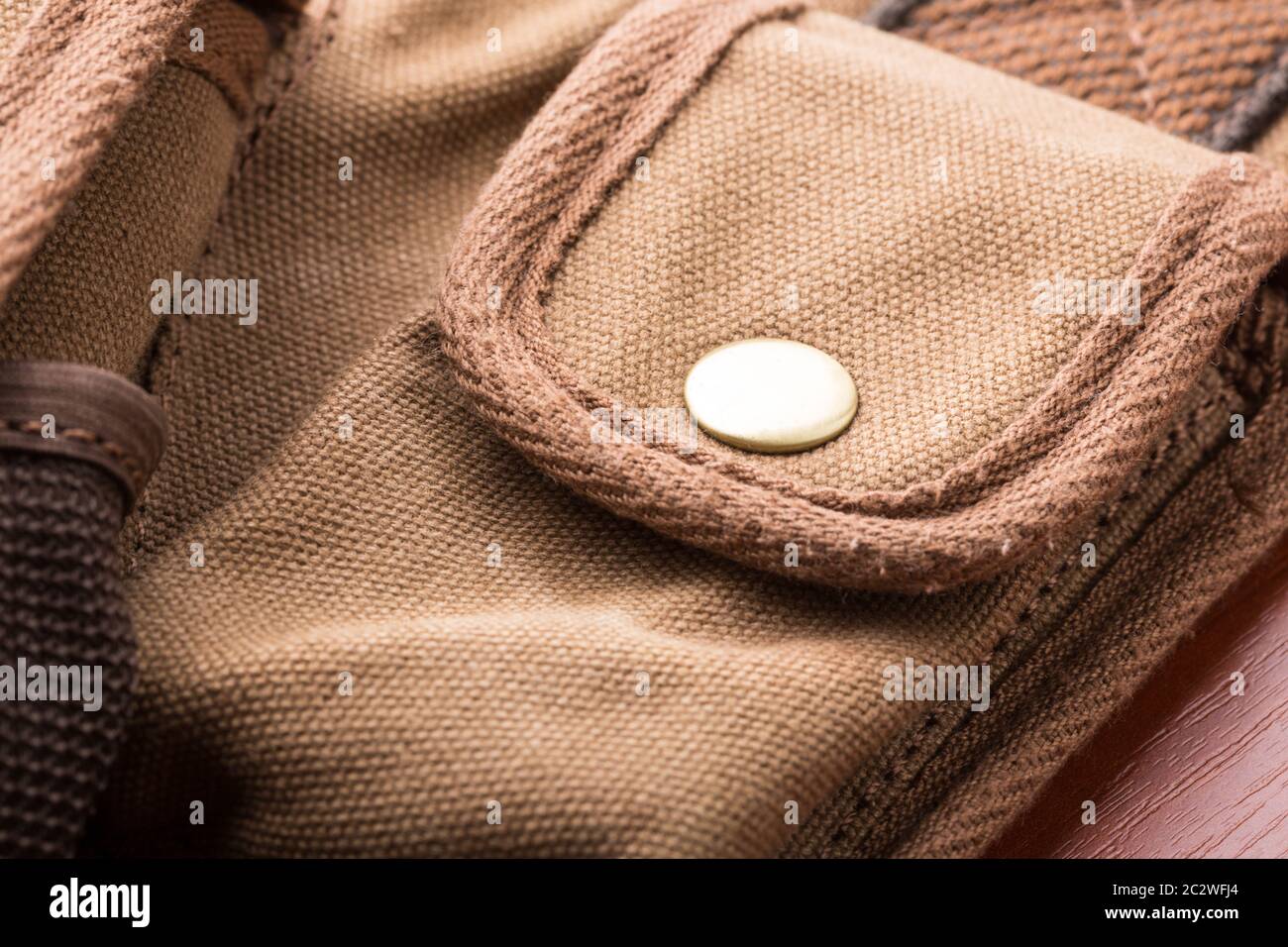 White button on small brown pocket Stock Photo - Alamy