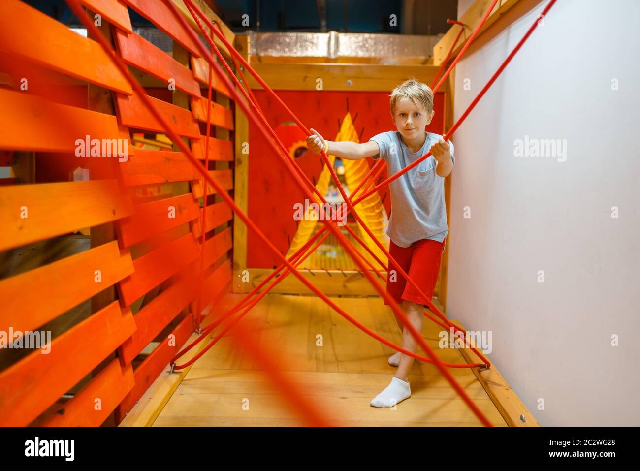 Little boy playing in rope labyrinth, playground in entertainment ...
