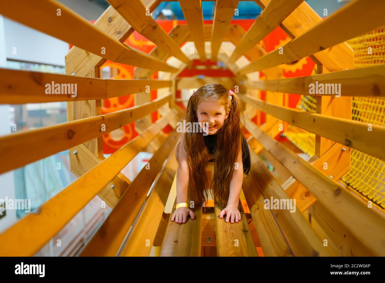Little girl playing in wooden labyrinth, playground in entertainment ...