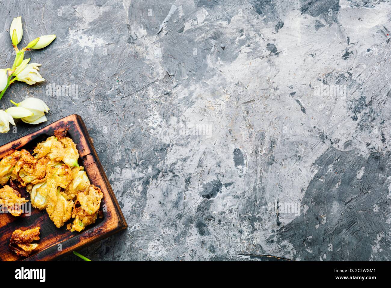 Fried yucca flowers.An unusual dish of edible flowers Stock Photo - Alamy