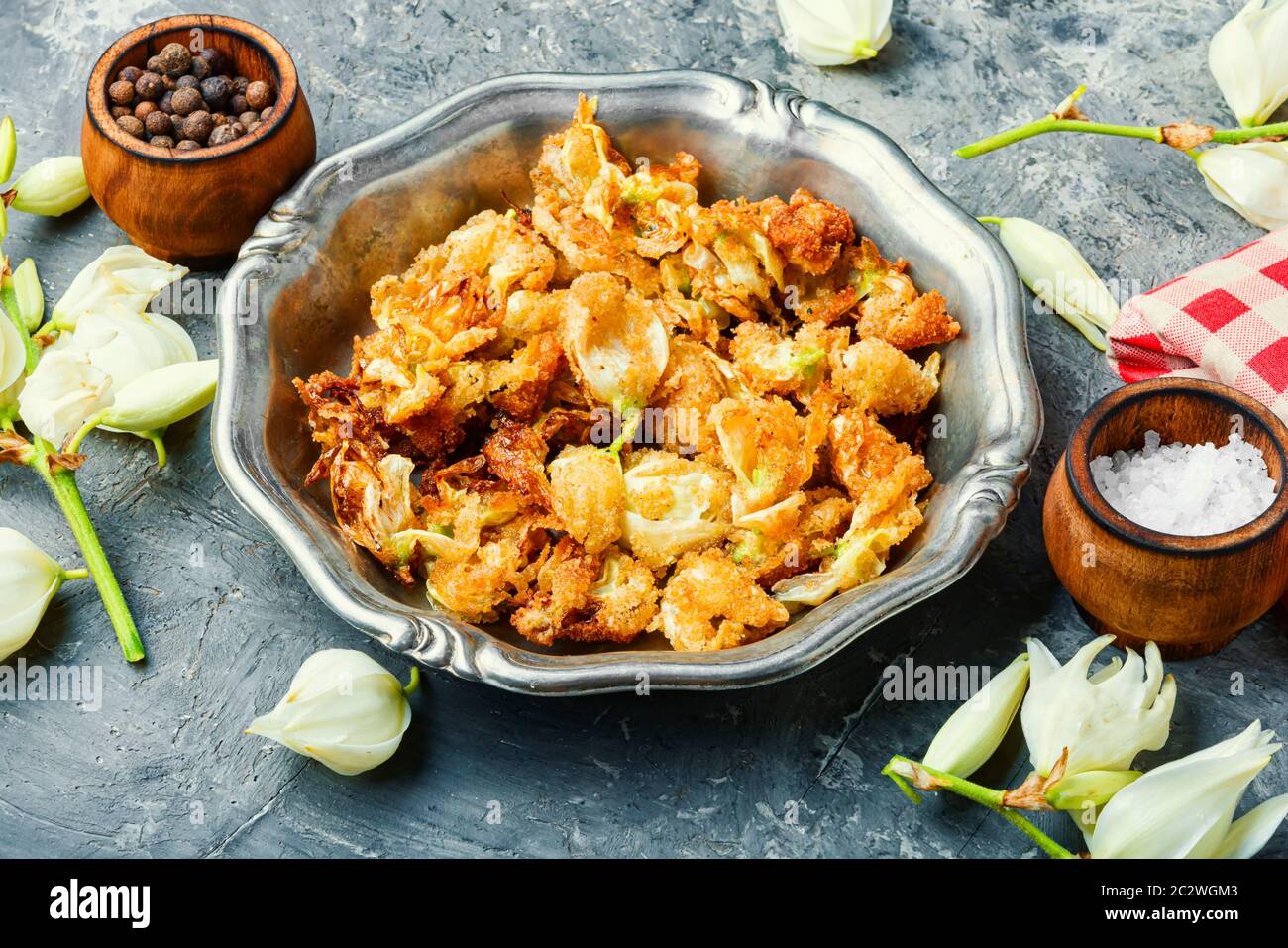 Fried yucca flowers.An unusual dish of edible flowers Stock Photo - Alamy