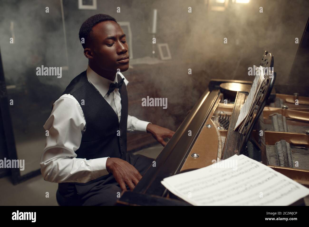 Ebony grand piano player performing classical music. Negro performer ...